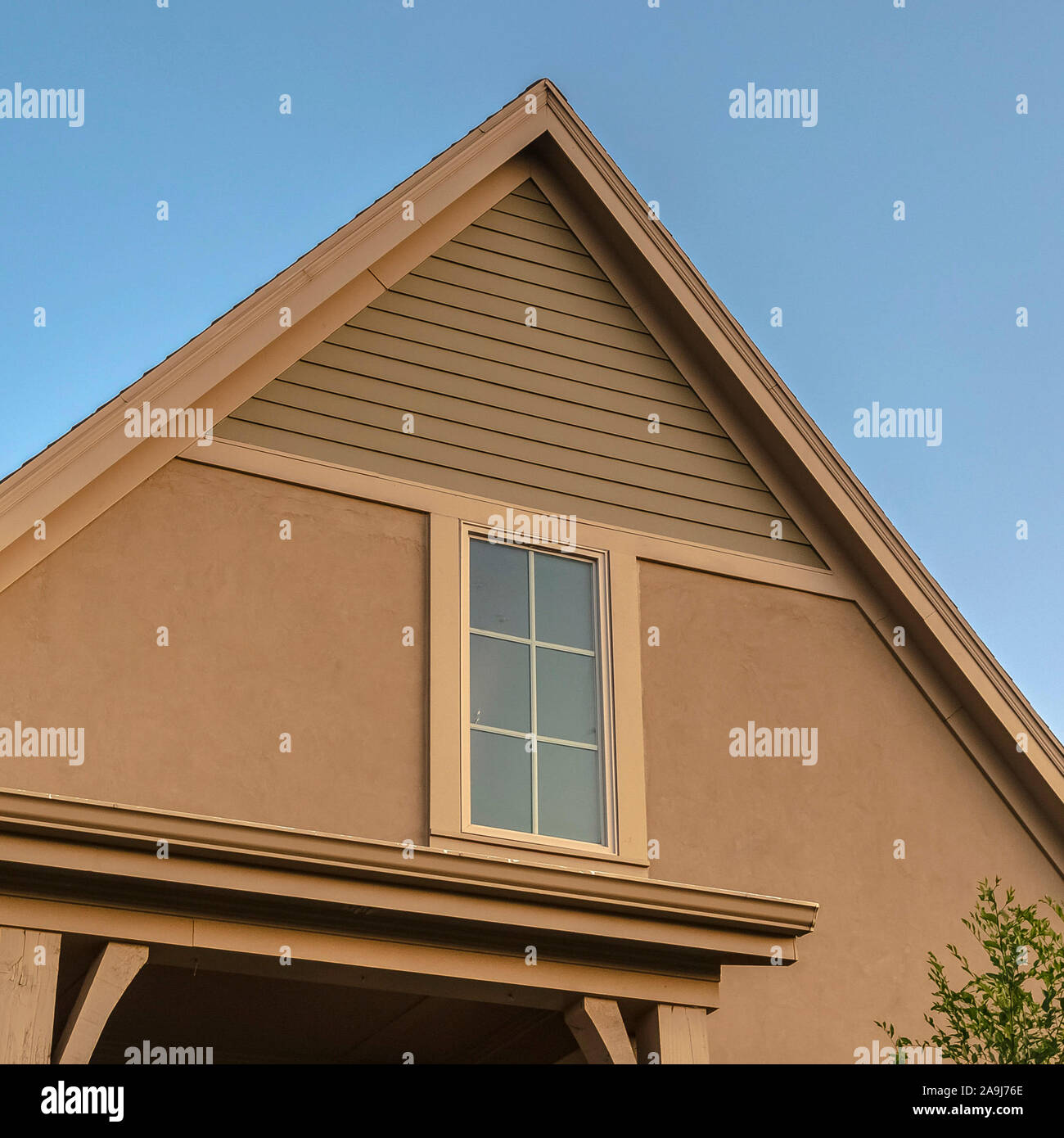 Square frame Top floor window in roof apex on a modern house Stock ...