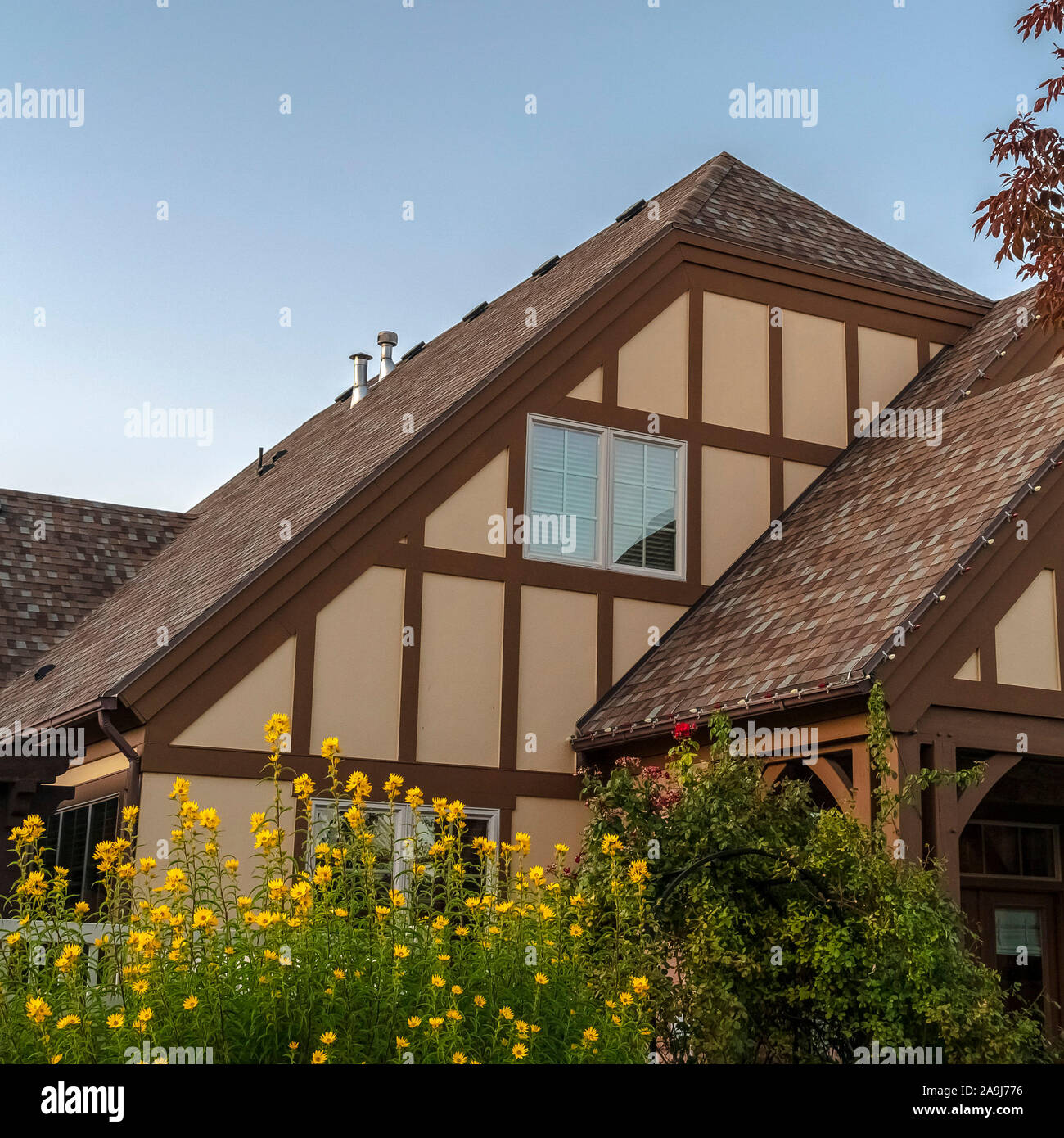 Square frame Unusual timber frame house with double apex roof Stock ...