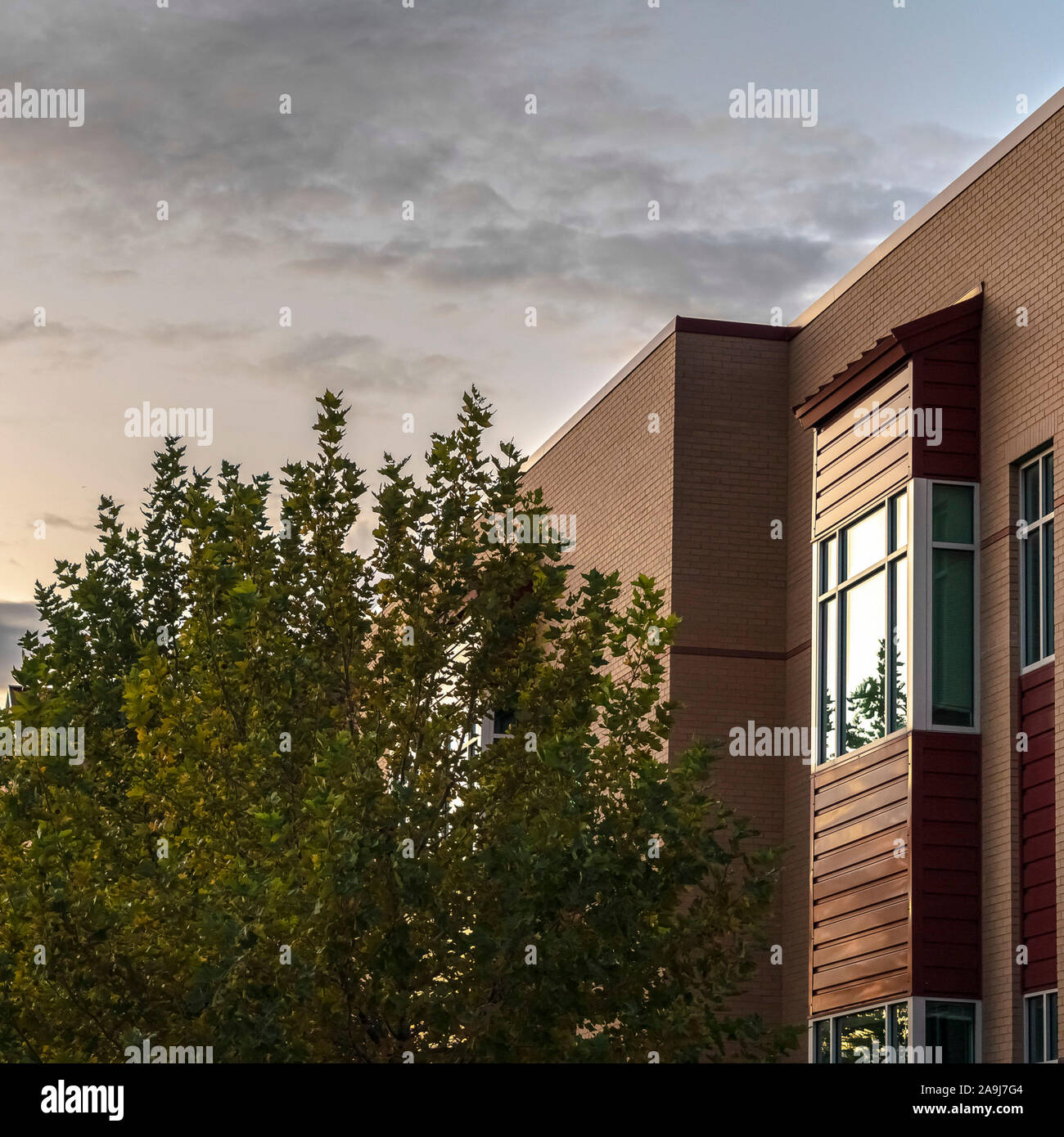 Square frame Corner of modern two storey building near sunset Stock ...