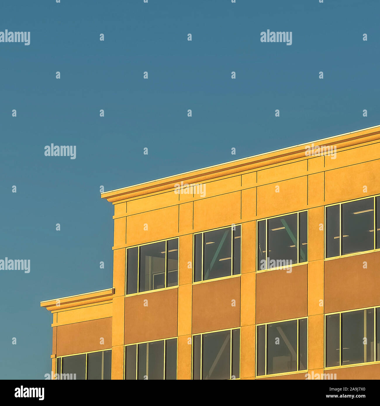 Square Commercial building exterior with mountain and sky background on ...