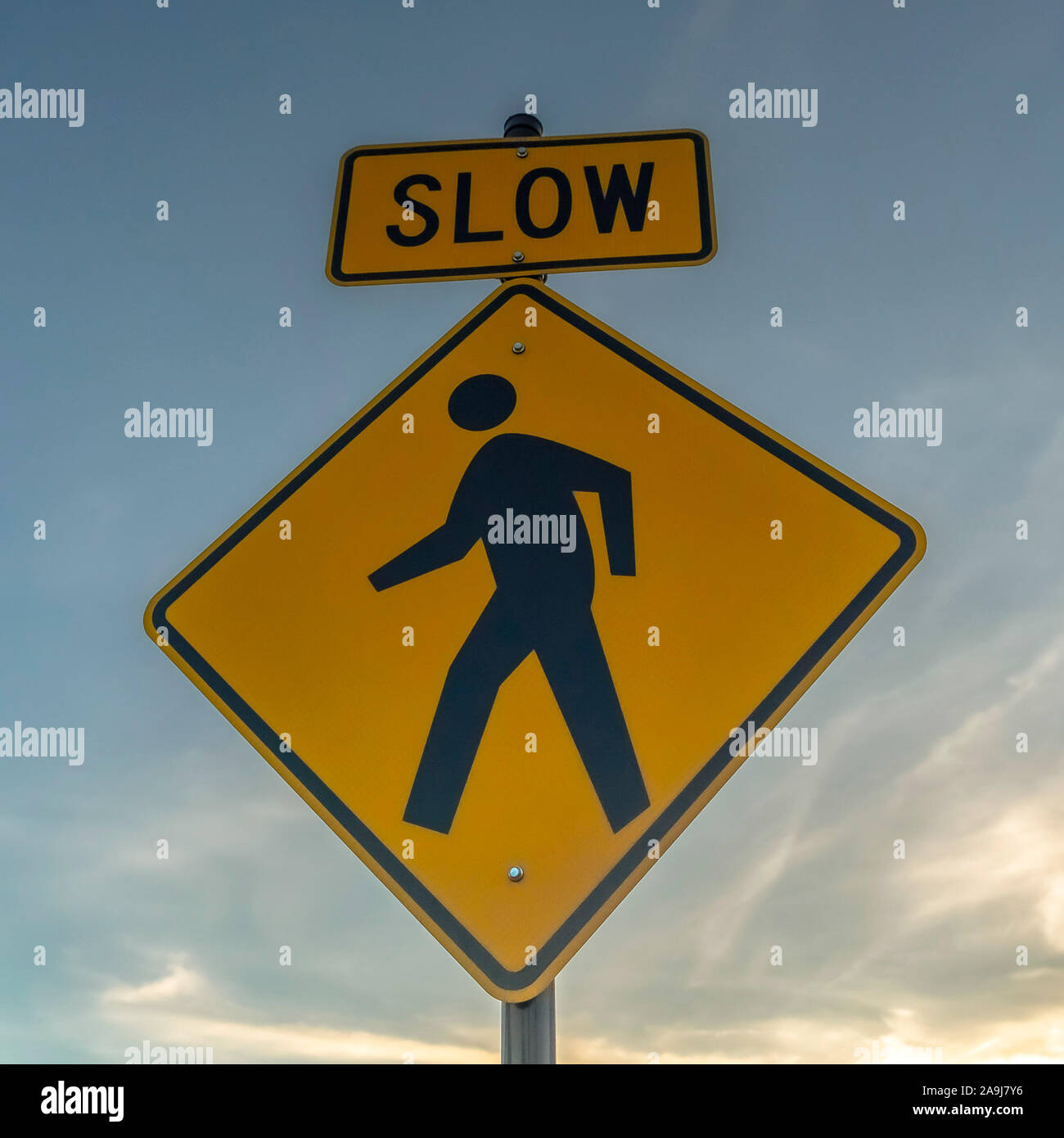 Square frame Yellow Slow sign and pedestrian crossing sign against ...