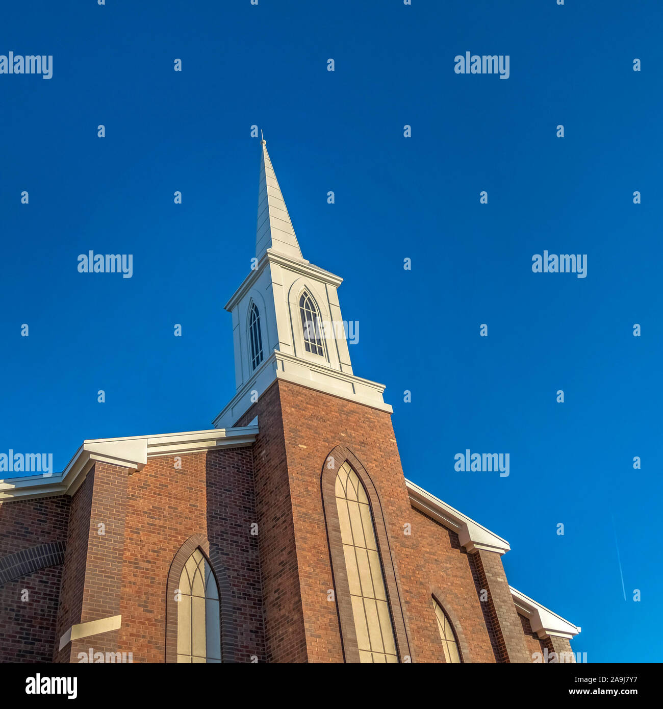 Square frame Church with classic red brick exterior wall and white ...