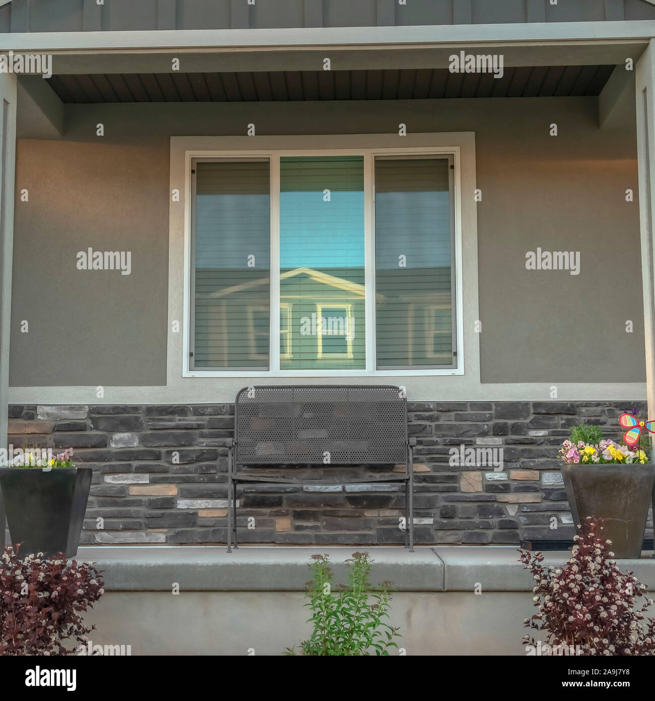 Square Front porch and yard of a family home with concrete outdoor ...