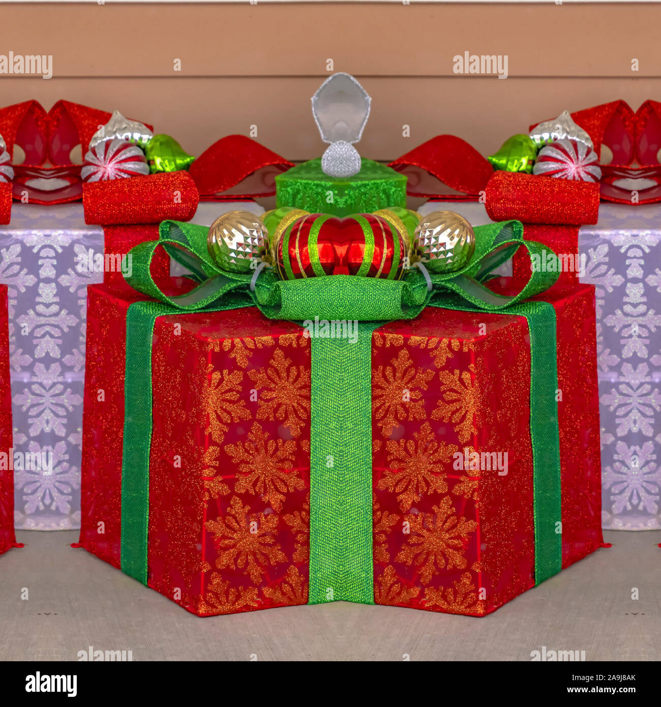 Square Close up view of Christmas presents with vibrant colorful wrappi ...