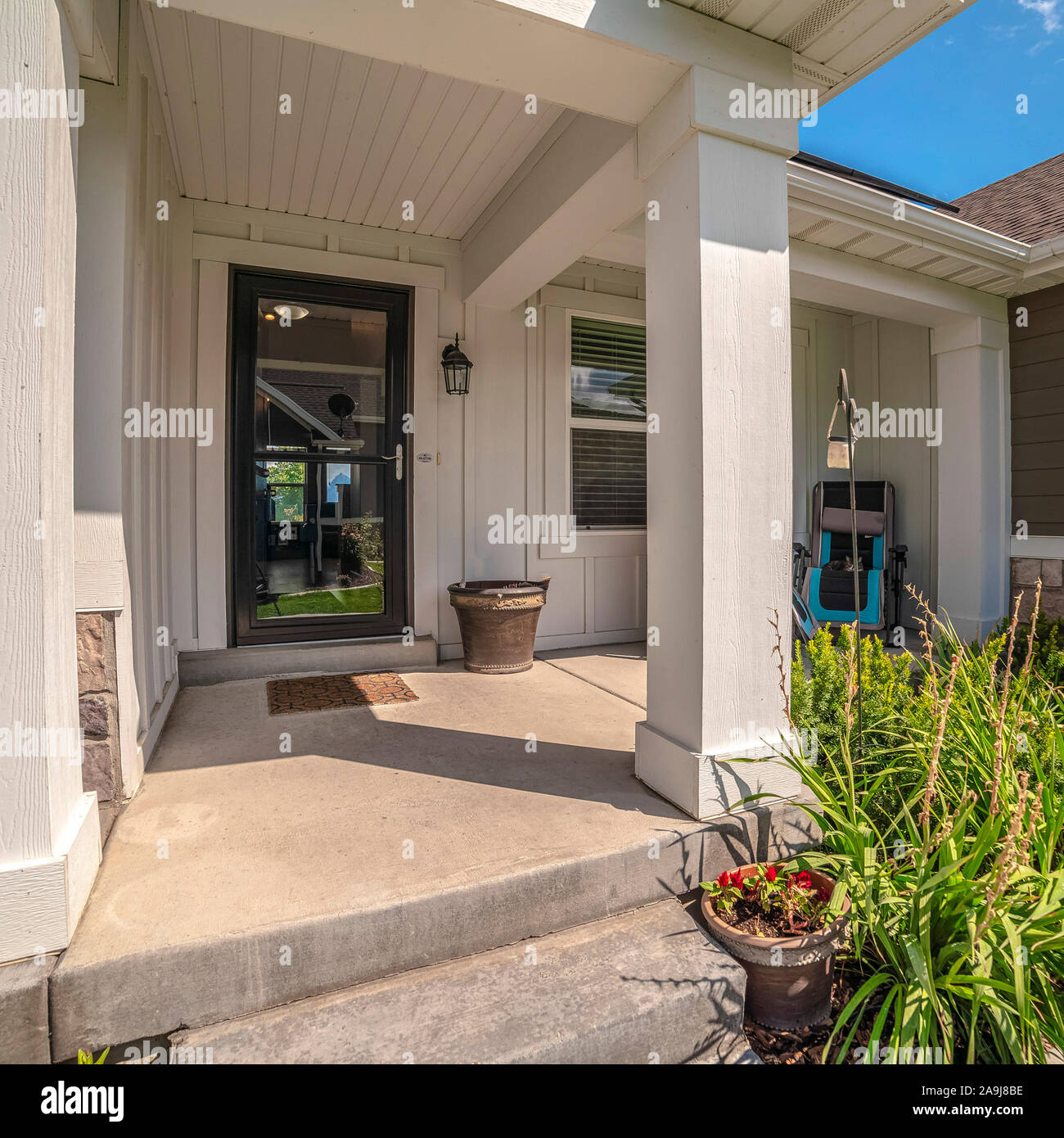 Square Covered porch and glass entrance door to a house Stock Photo - Alamy