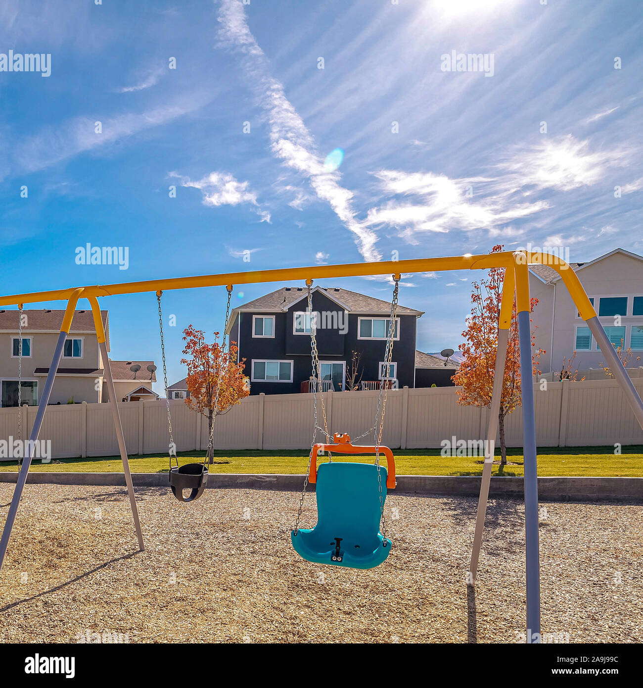 Square frame Empty kids swing on a playground in an estate Stock Photo ...