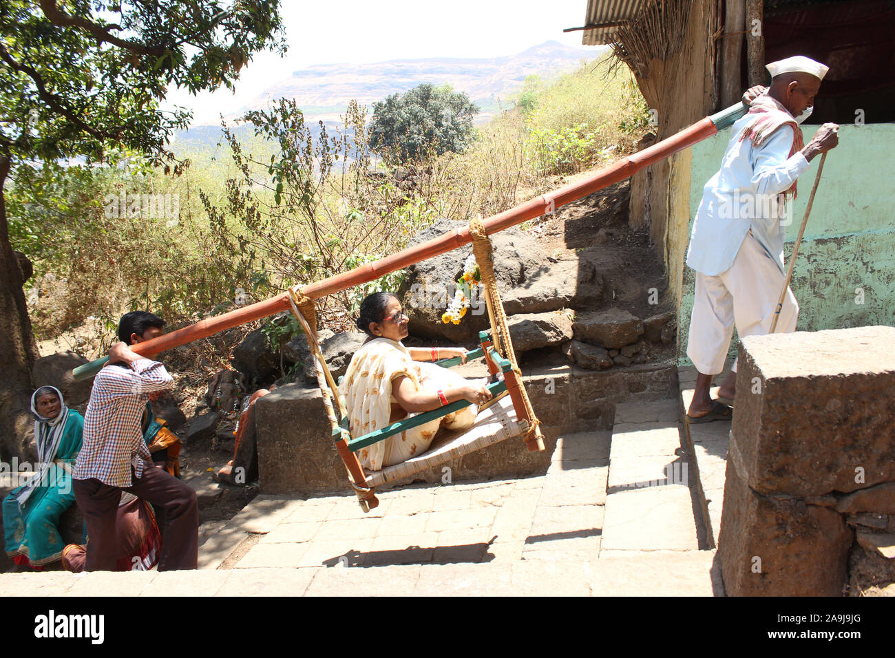 NASHIK, MAHARASHTRA, INDIA, April 2019, Women being carried on a human ...