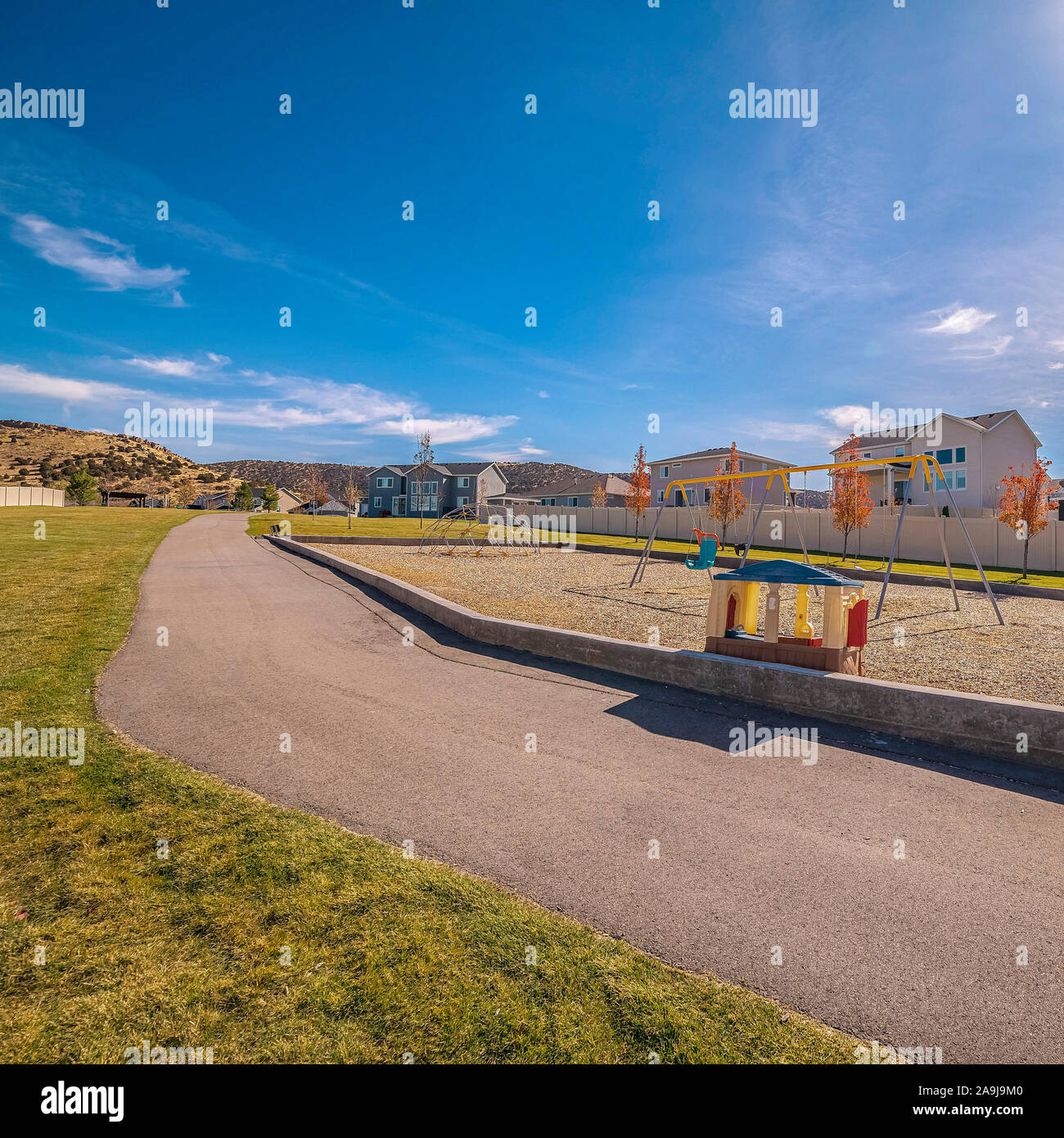 Square frame Deserted pedestrian walkway and kids playground during day ...
