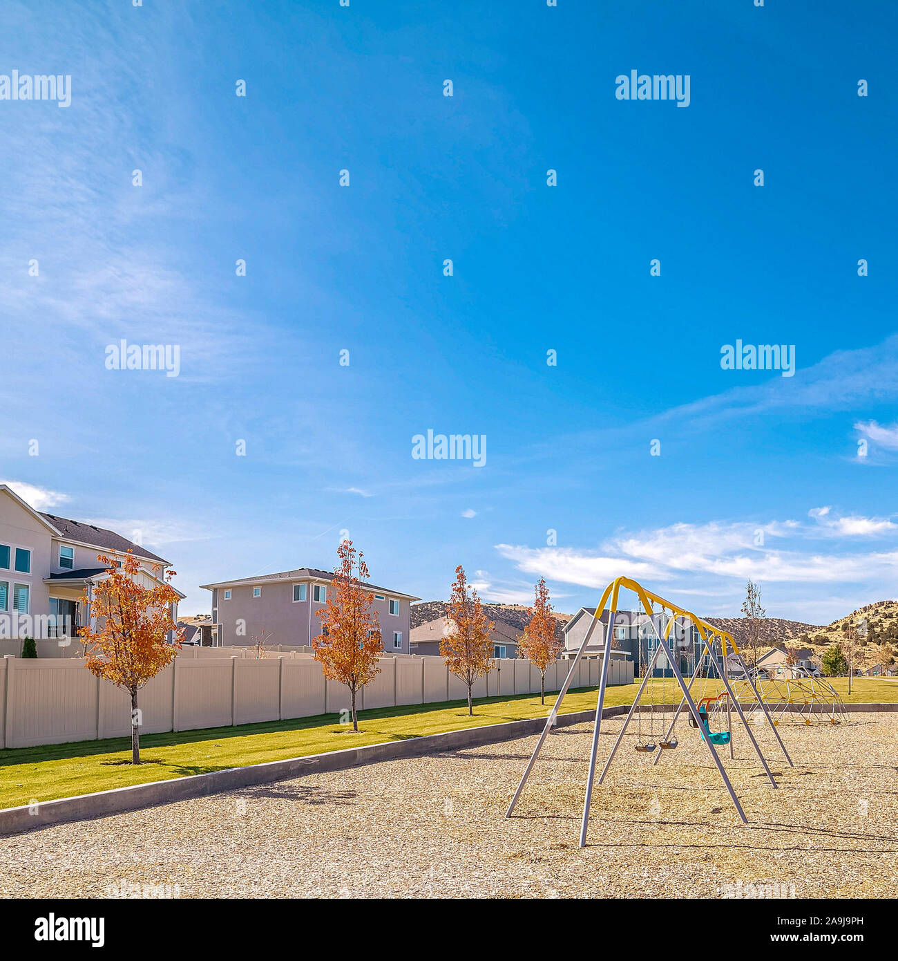 Square Empty bench overlooking a small kids playground Stock Photo - Alamy
