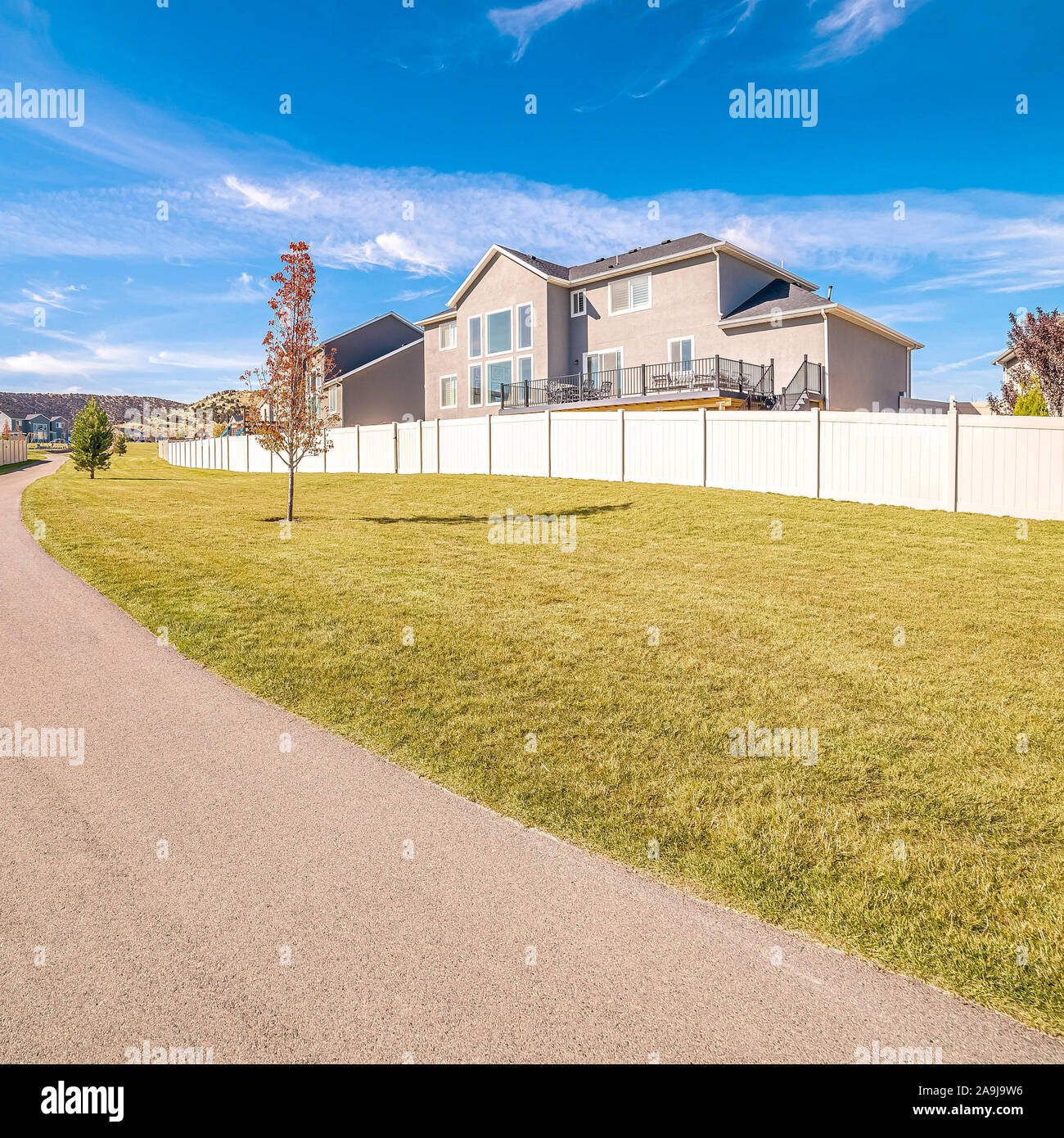 Square frame Curving pedestrian walkway in a greenbelt area Stock Photo ...