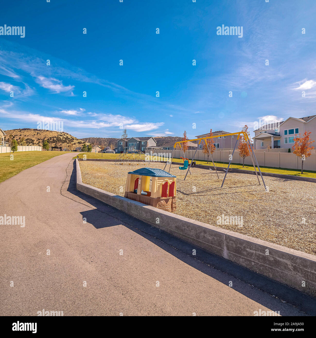Square frame Empty pedestrian walkway passing a kids playground Stock ...