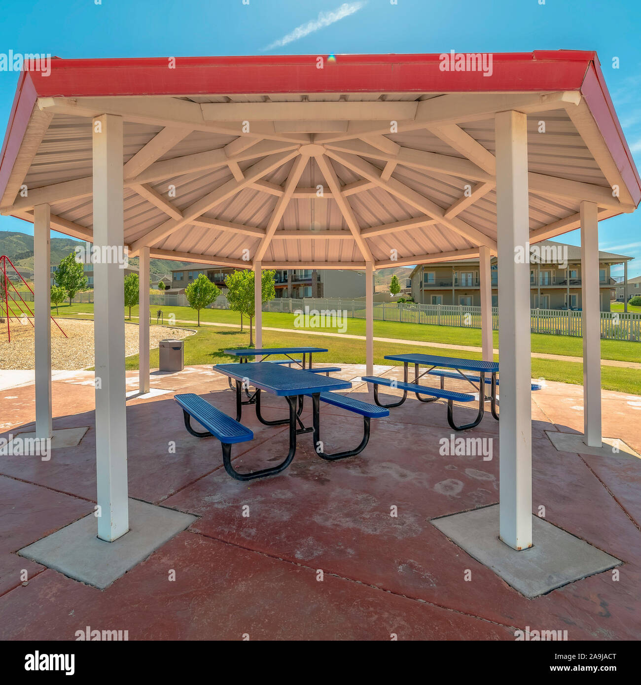 Square Octagon shape pavilion with blue tables and benches at a ...