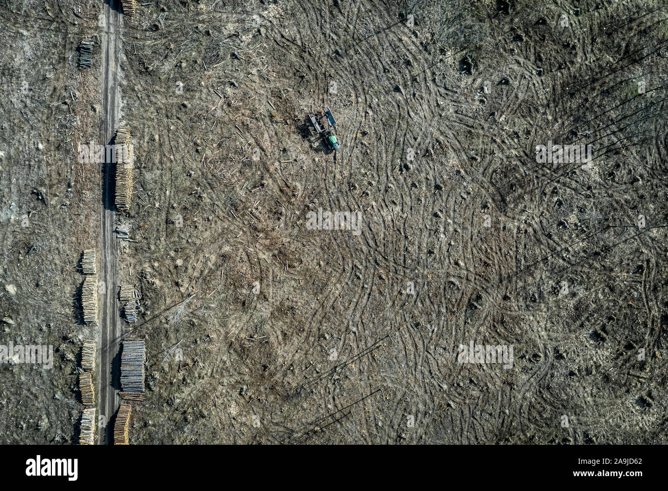 Small tractor in the middle of deforestation forest, aerial view Stock ...