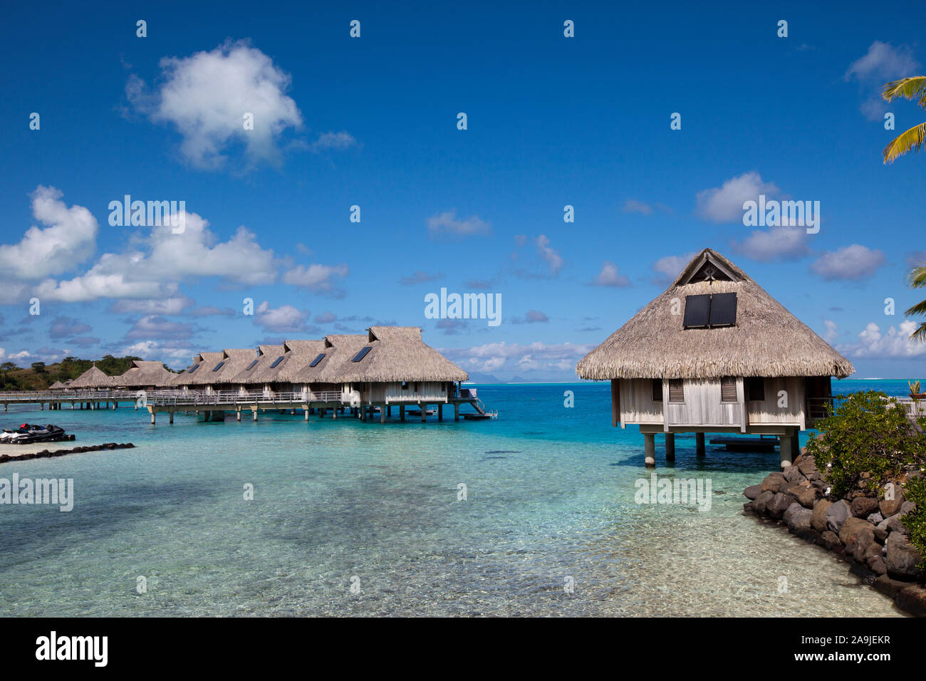authentic traditional Polynesian houses with thatched roof above the ...