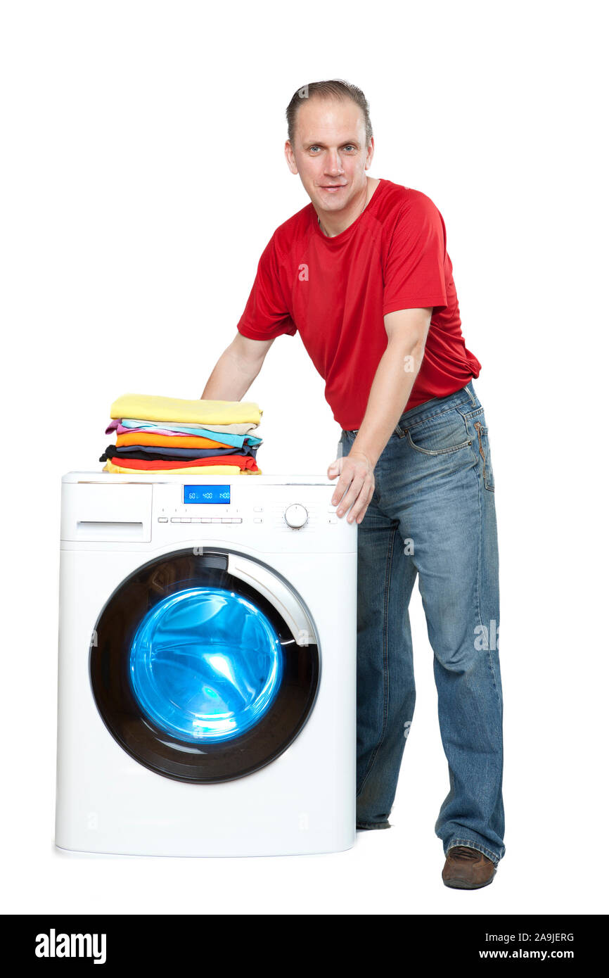happy man smiling standing next to a new washing machine Stock Photo ...