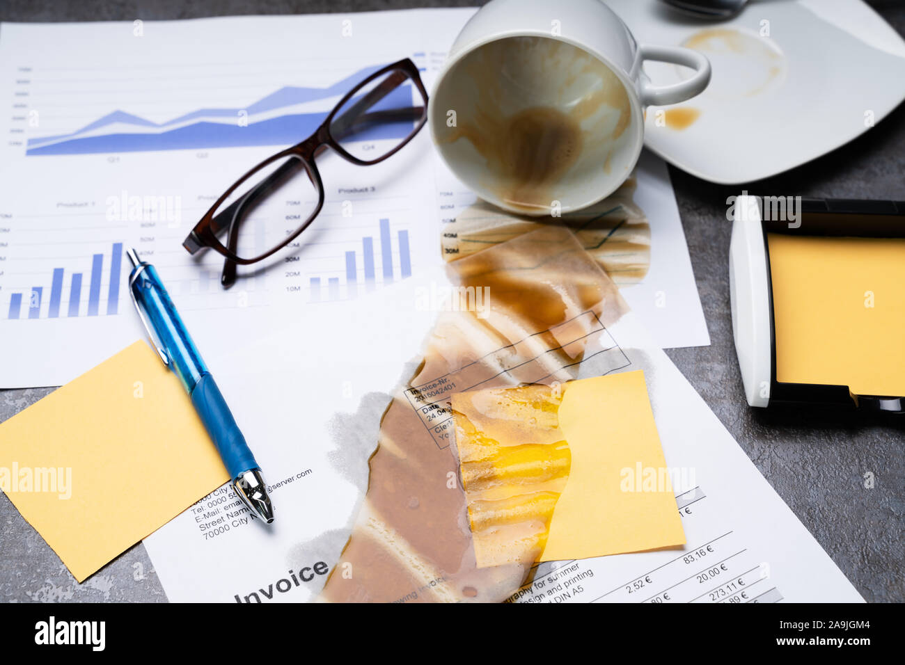 Close-up Of Coffee Spilling Out From Cup Over Graph And Invoice On ...