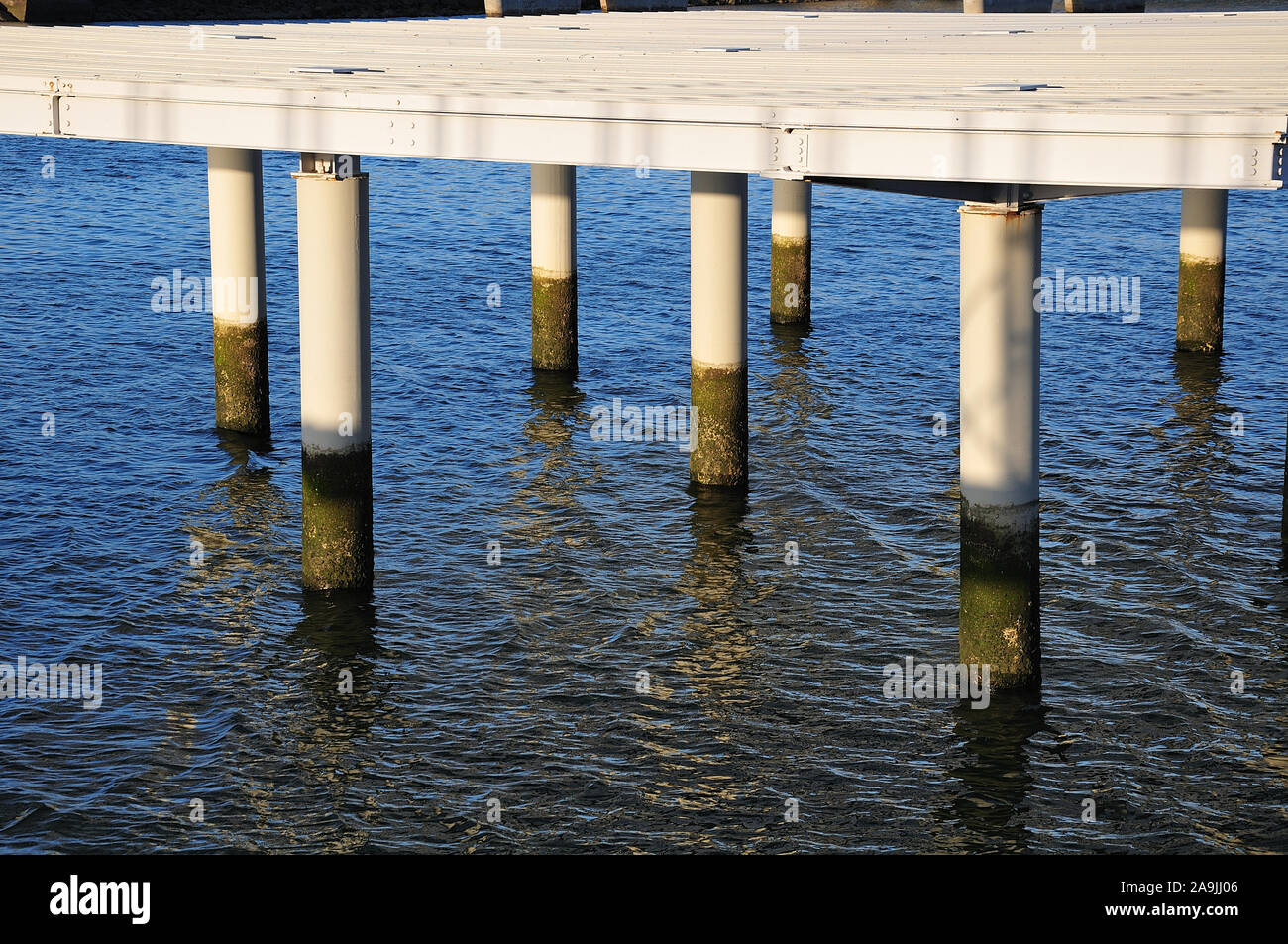 metal platform on concrete columns at riverside in evening sun Stock ...