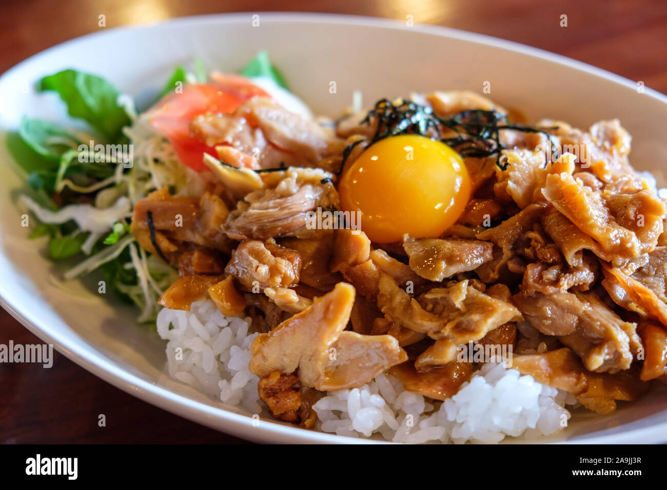 Chicken and raw Egg Rice with vegetables Stock Photo - Alamy