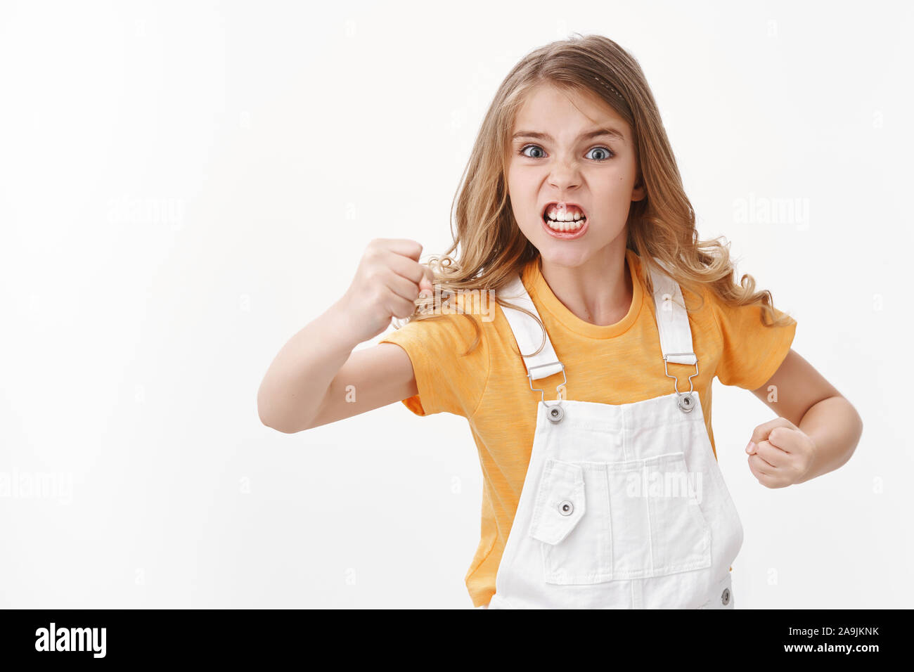 Angry displeased and distressed hateful blond little girl, child ...