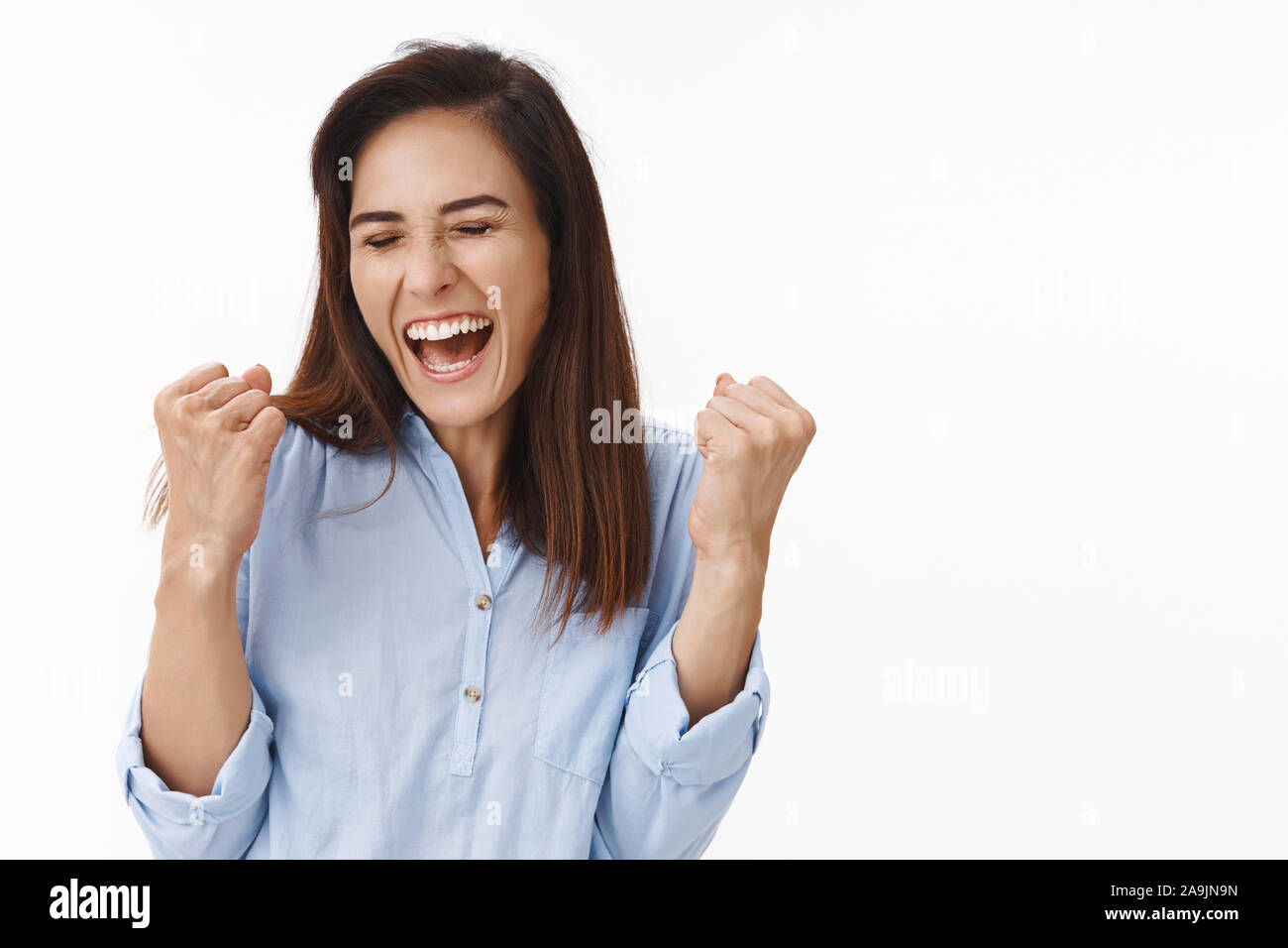 Excited successful ambitious middle-aged brunette woman in office blue ...