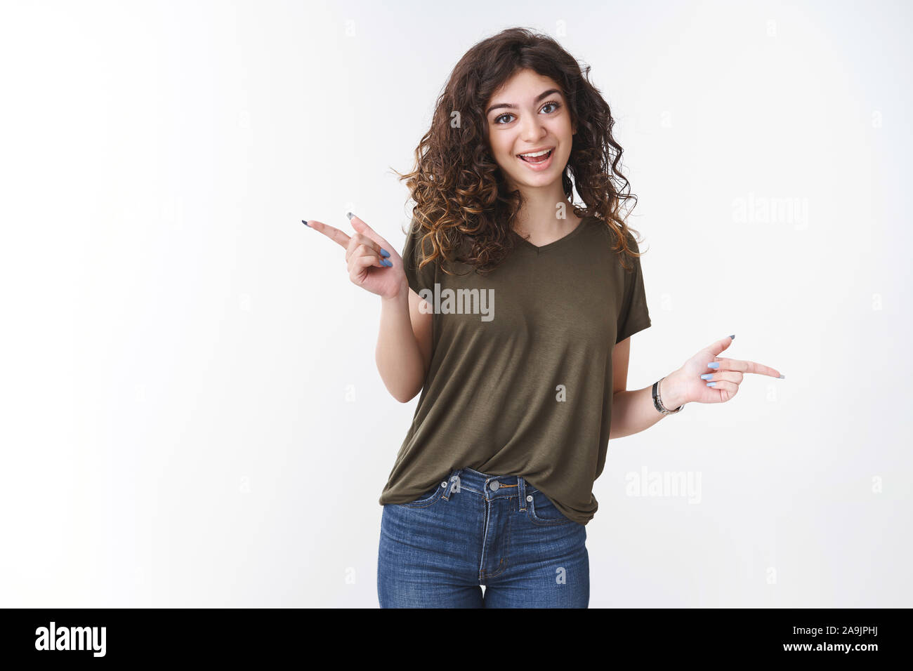 Cheeky cute outgoing party girl with curly hair wearing olive t-shirt ...