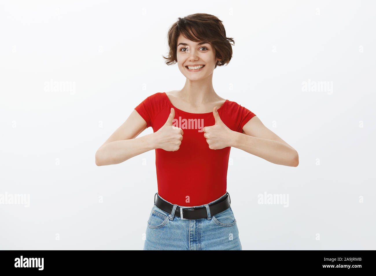 Cheerful lively cute feminine supportive happy girl short haircut show ...