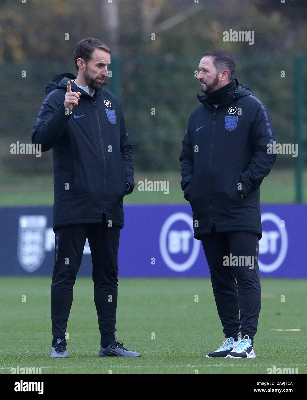 England head coach Gareth Southgate (left) during the training session ...