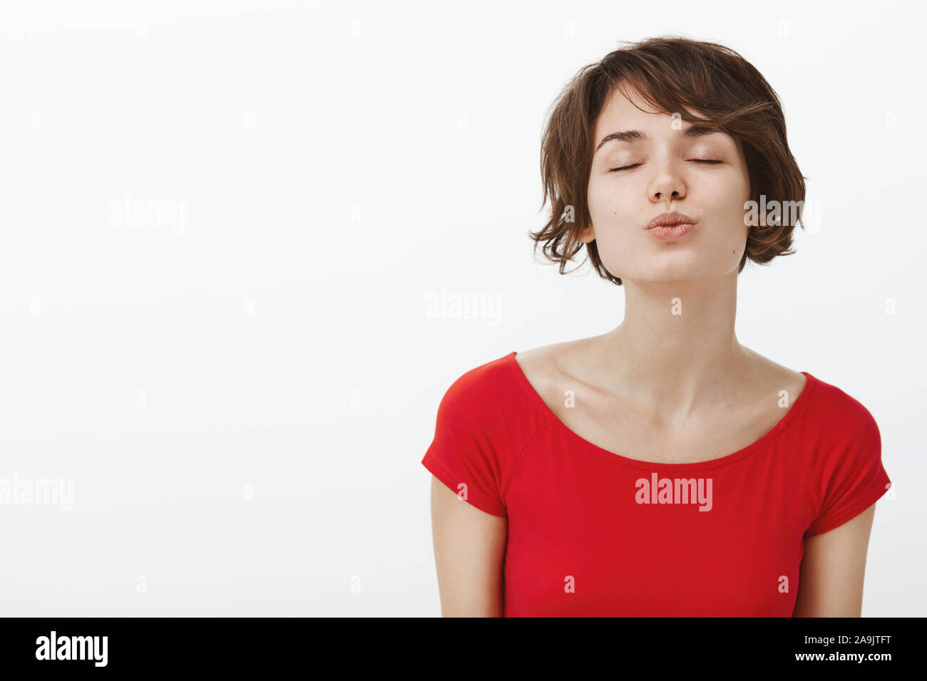 Wanna feel your love. Lovely romantic cute woman lean foward give kiss ...