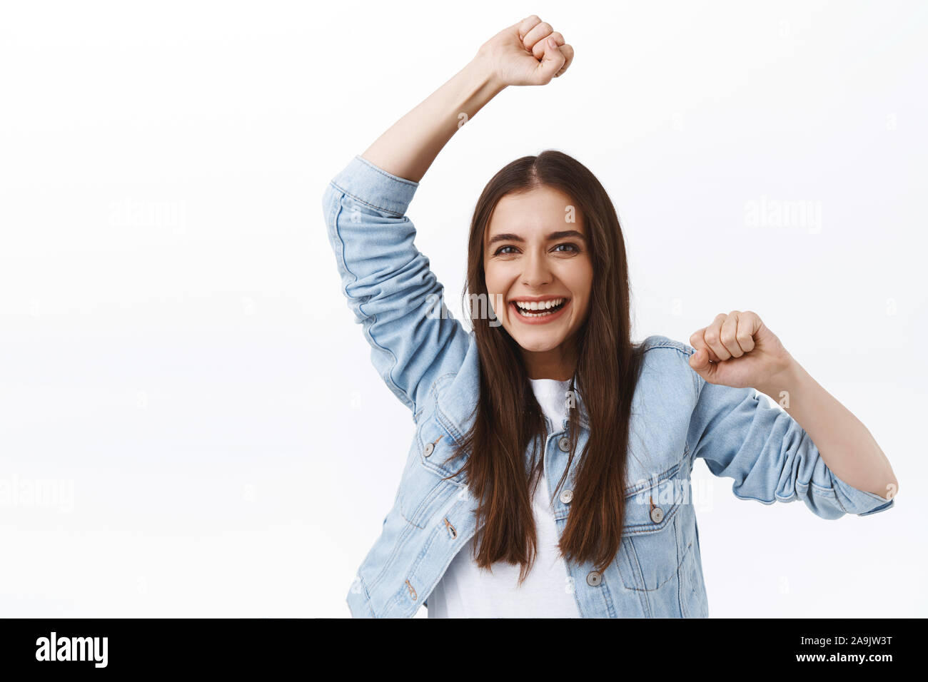 Cheerful excited girl smiling happily, dancing triumphing as team ...