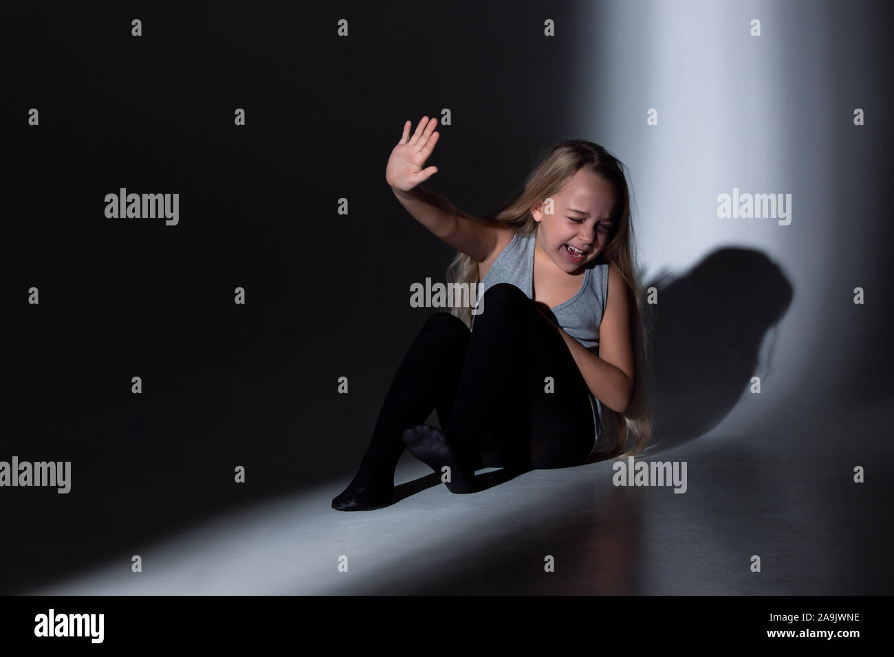 Sad and frightened little girl with bloodshot, bruised eyes crying ...