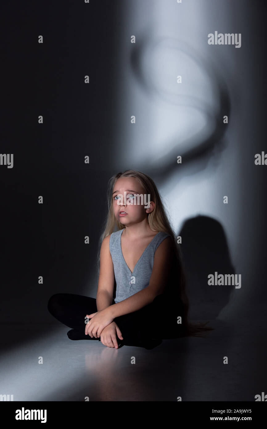 Sad and frightened little girl with bloodshot, bruised eyes crying ...