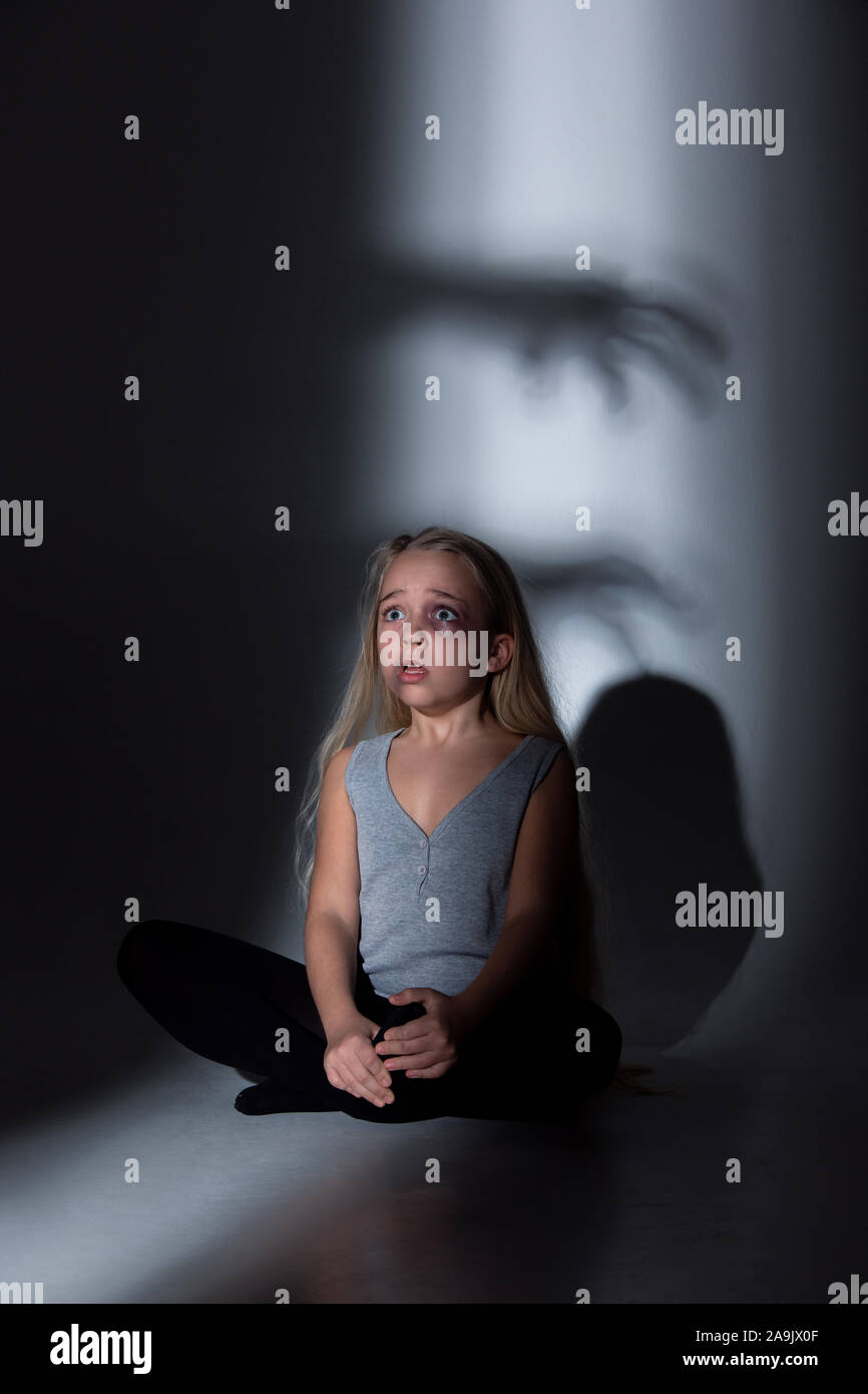Sad and frightened little girl with bloodshot, bruised eyes crying ...