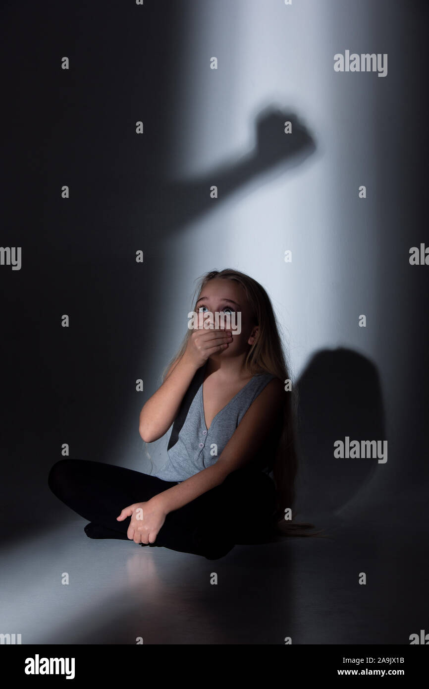 Sad and frightened little girl with bloodshot, bruised eyes crying ...