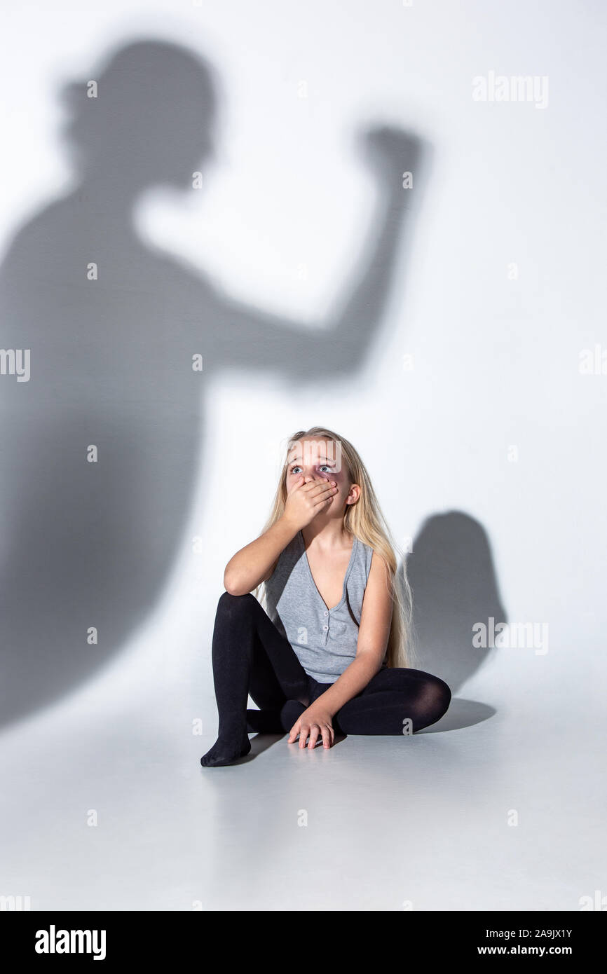 Sad and frightened little girl with bloodshot, bruised eyes crying ...