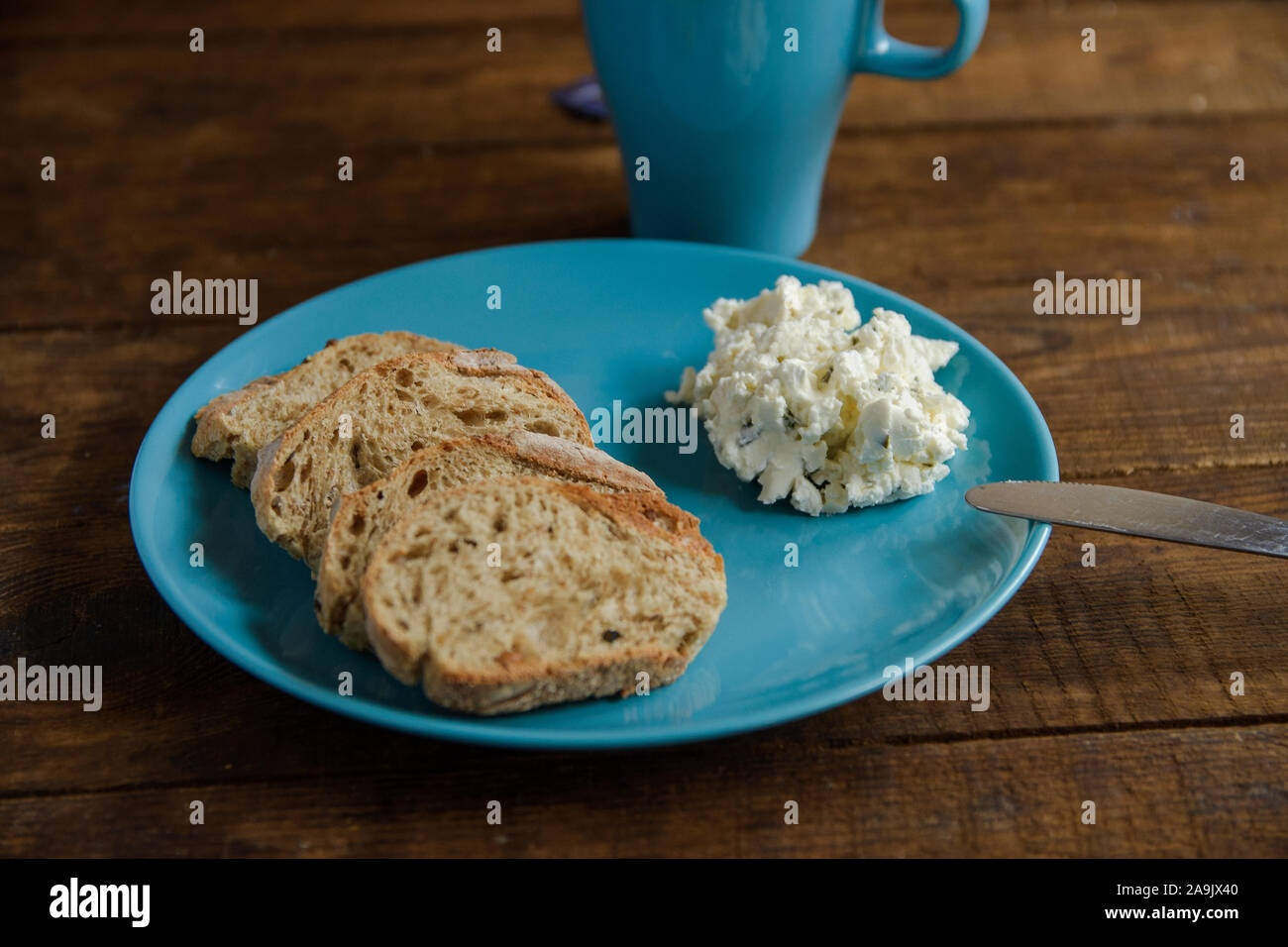 Breakfast bread toast on a blue plate with soft cheese Stock Photo - Alamy