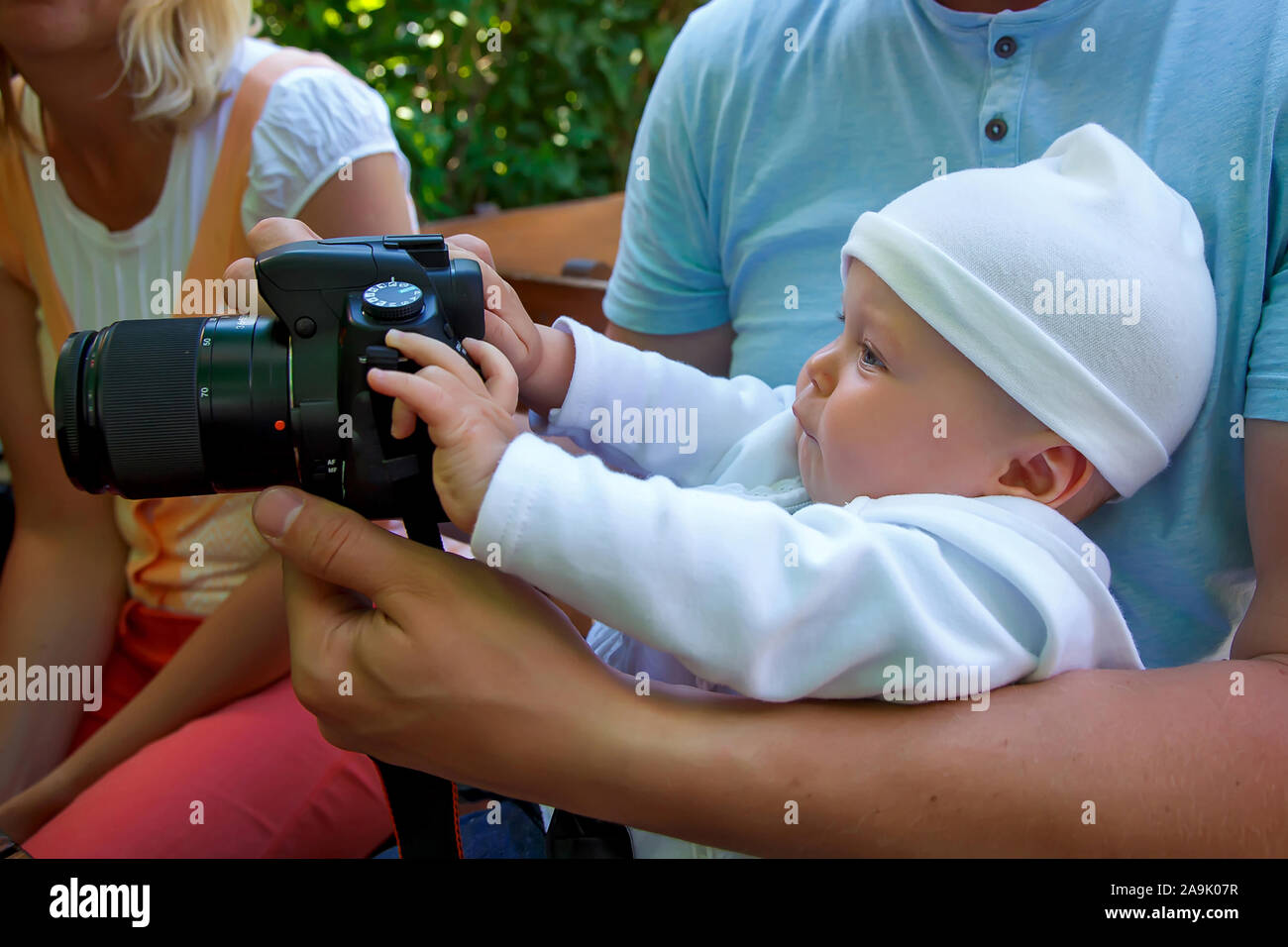 Little photographer with a big camera on the hands of dad Stock Photo ...