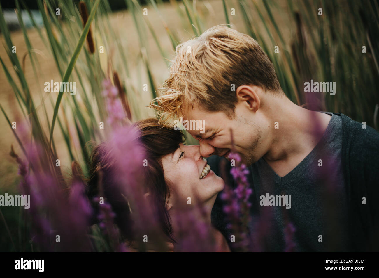 young heterosexual couple in love smiling at each other Stock Photo - Alamy