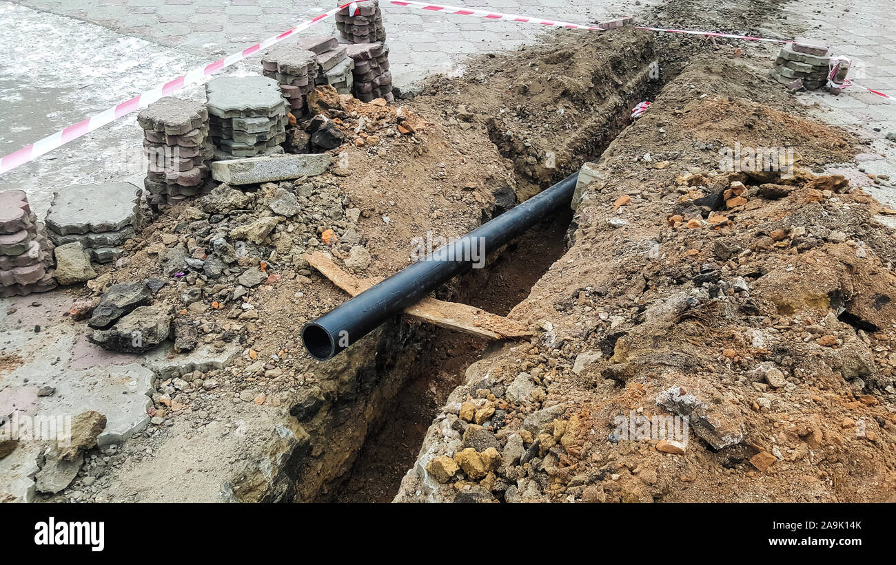 Laying installation of a new cable in a plastic pipe. Digging drilling ...