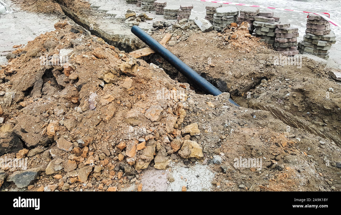 Laying installation of a new cable in a plastic pipe. Digging drilling ...