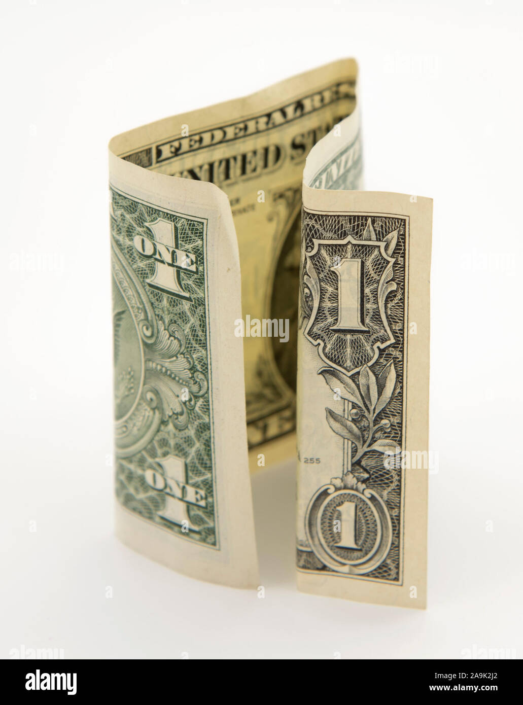 One folded dollar on a light background Stock Photo - Alamy