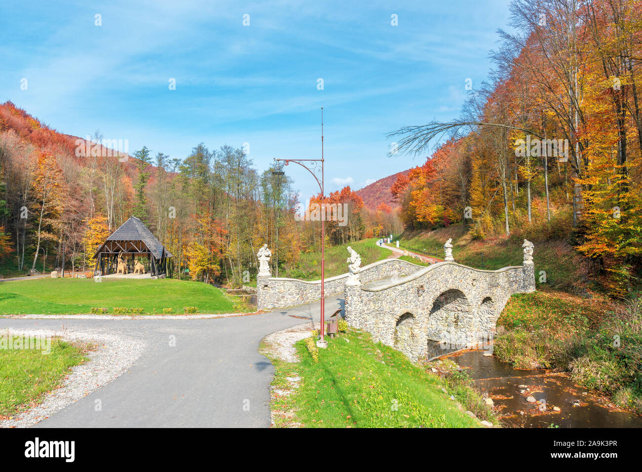 beautiful autumn scenery in the park. bridge across the forest stream ...