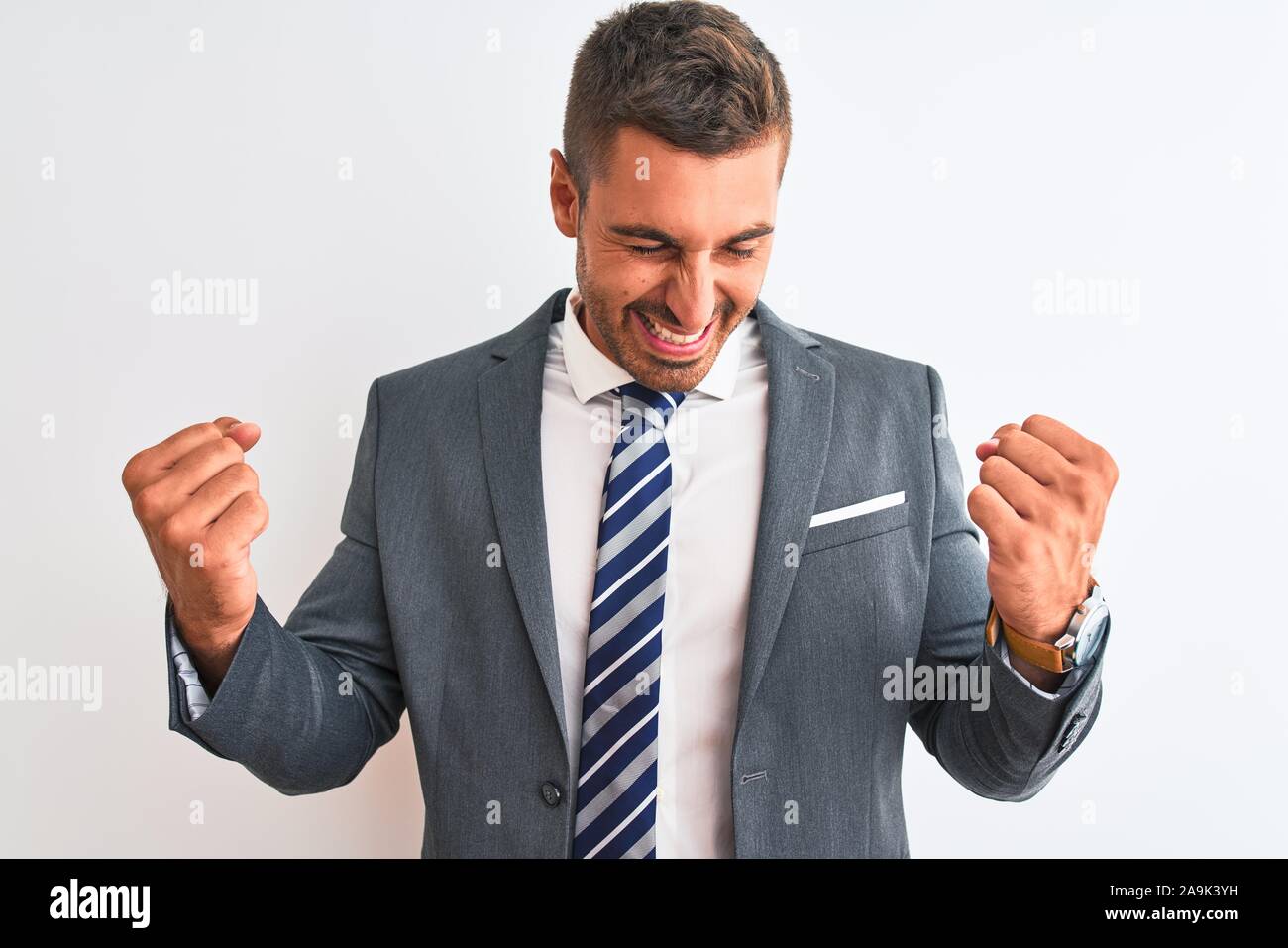 Young handsome business man wearing suit and tie over isolated ...