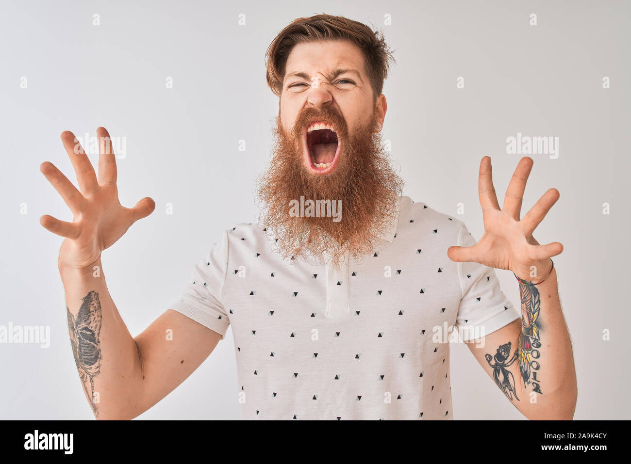 Young redhead irish man wearing polo standing over isolated white ...