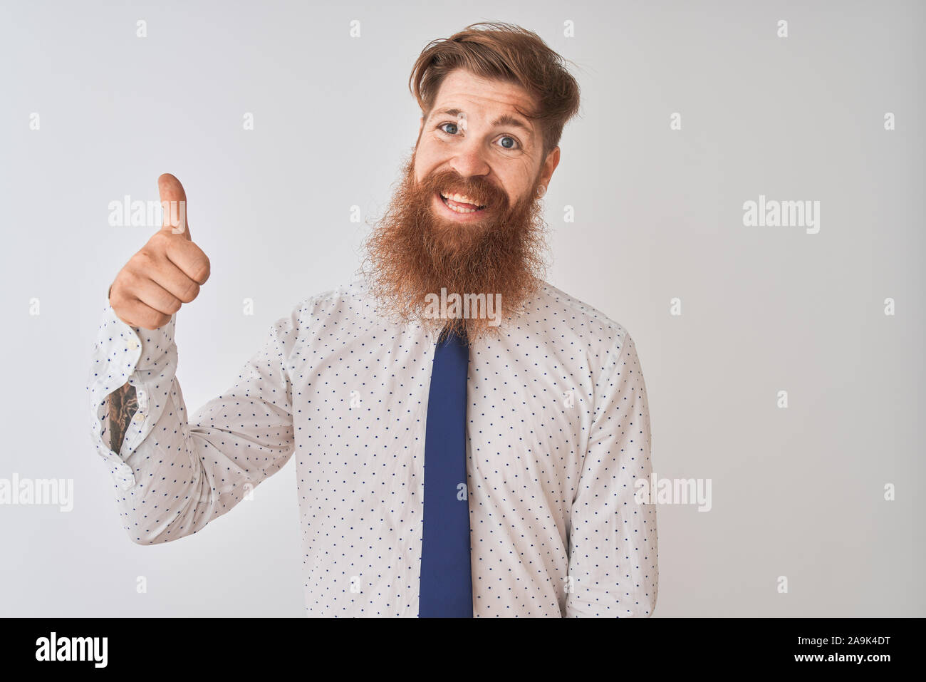 Young redhead irish businessman standing over isolated white background ...