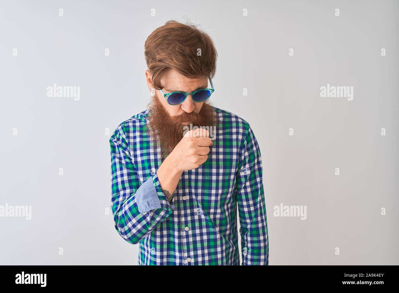Young redhead irish man wearing casual shirt and sunglasses over ...