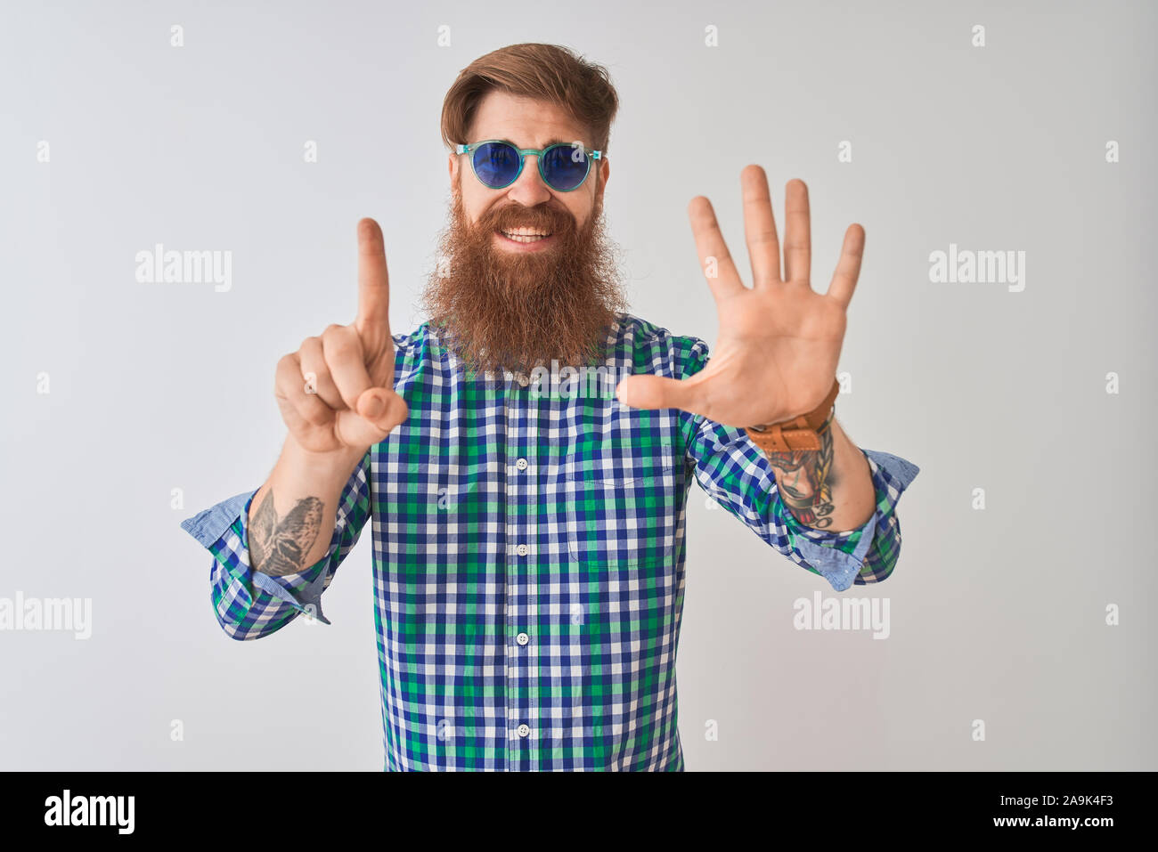 Young redhead irish man wearing casual shirt and sunglasses over ...