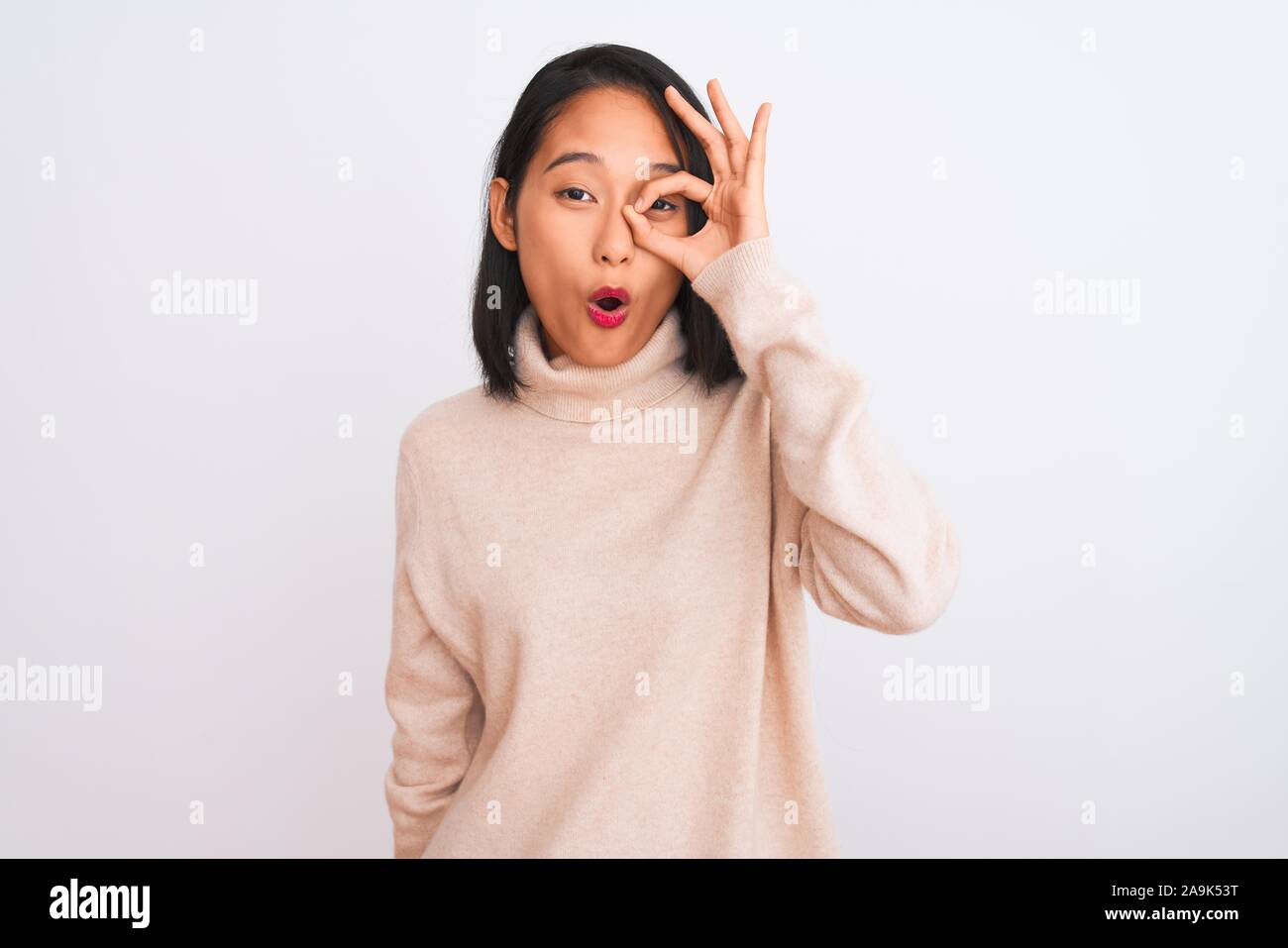 Young chinese woman wearing turtleneck sweater standing over isolated ...