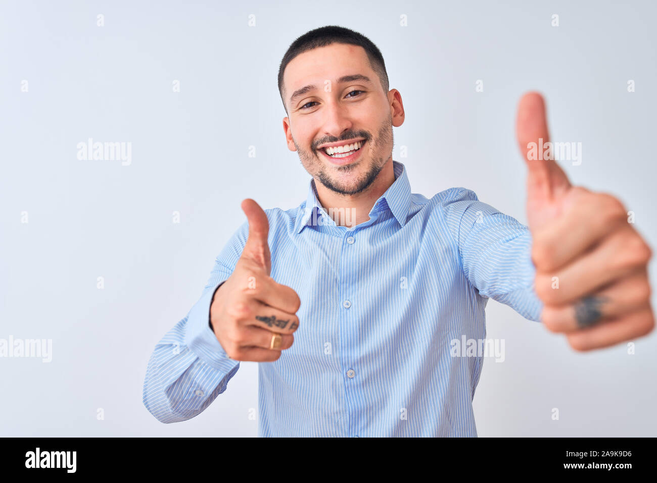 Young handsome business man standing over isolated background approving ...