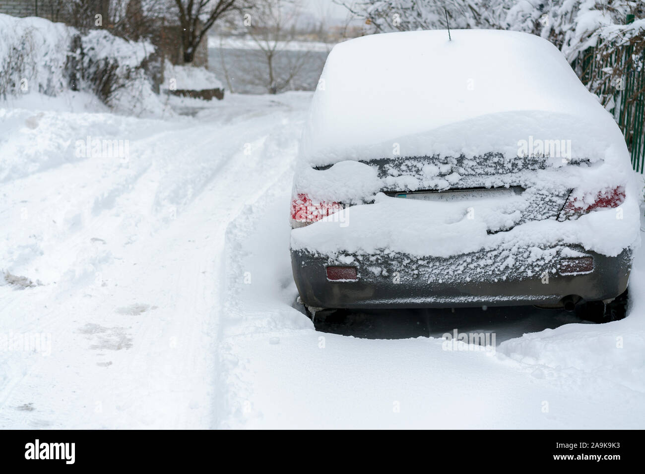 Snow-covered machine. Car under the snow. Lots of snow and big ...