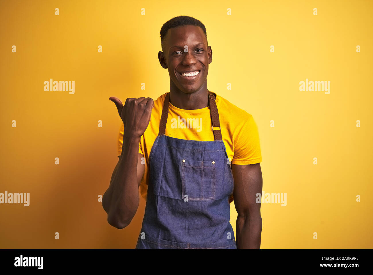 African american bartender man wearing apron standing over isolated ...